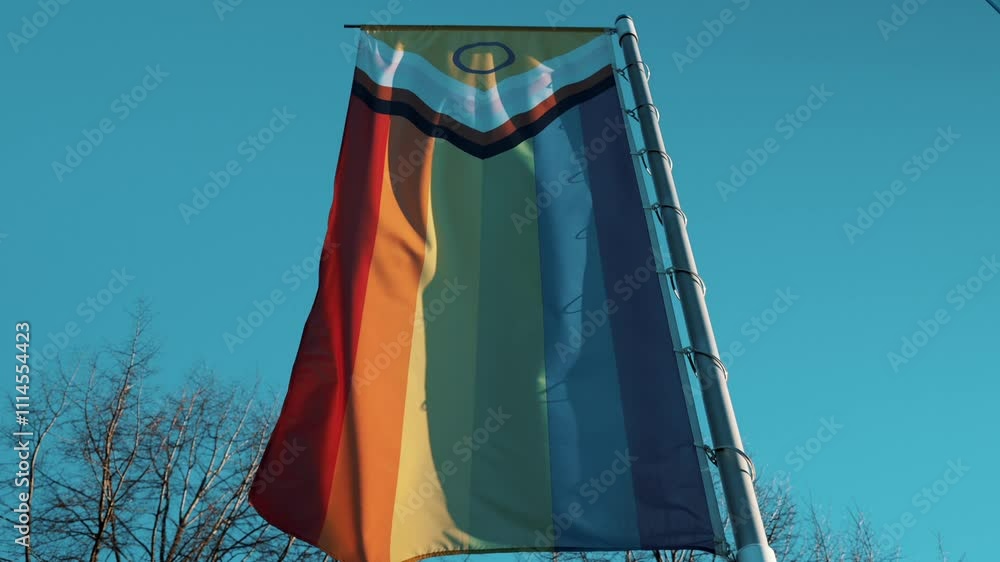 New Progress Pride Flag waving proudly outdoors on a pole, symbolizing ...