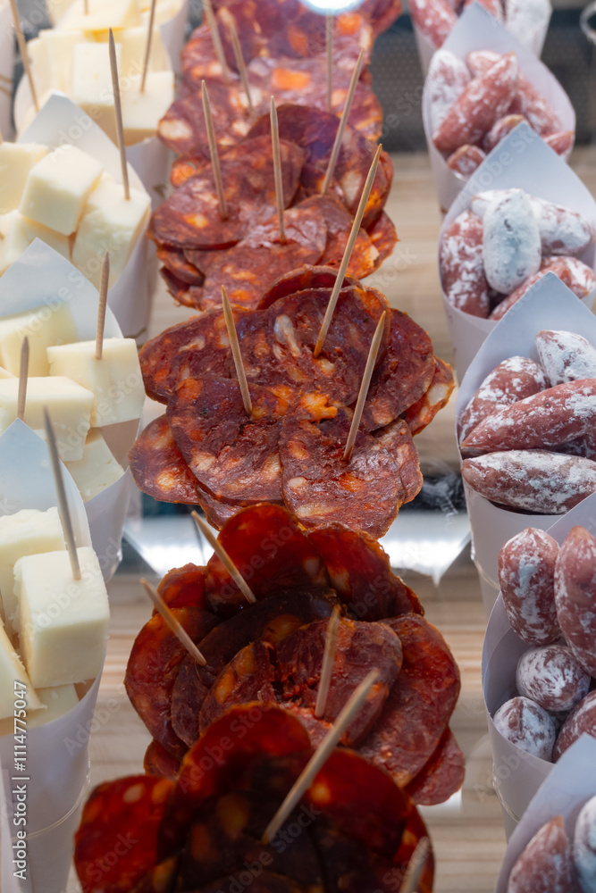 Spanish street food, snack, tapas, sliced sausages, cheese, dry-cured ...