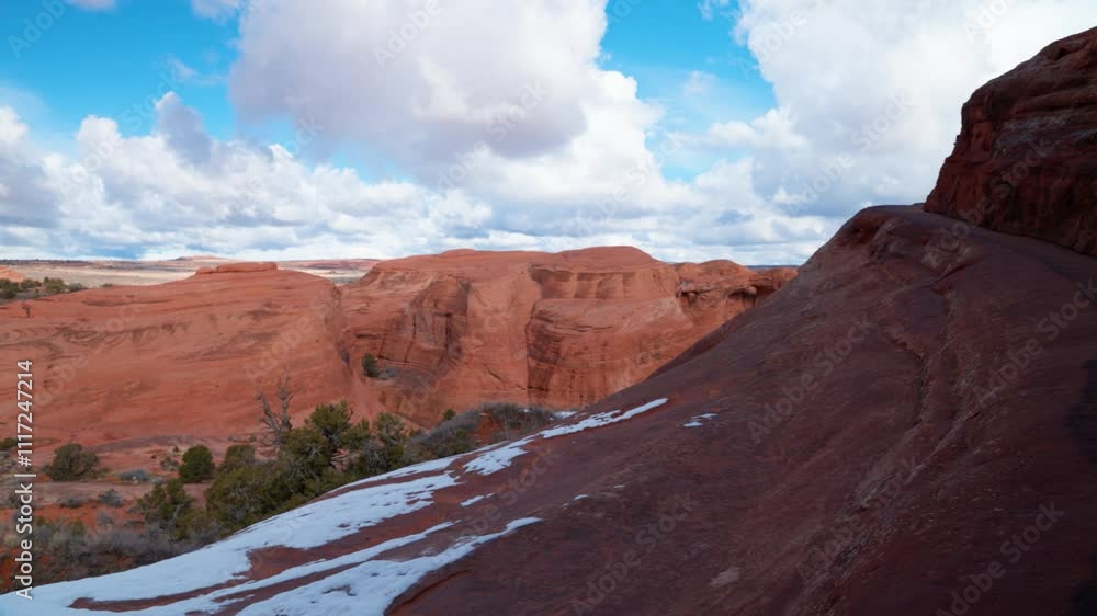Panning shot showcasing a hiking trial on the edge of a cliff then ...