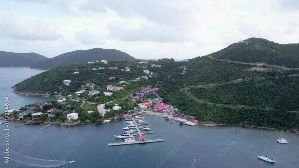 An aerial view of a cloudy day over Leverick Bay in the BVI as a boat ...