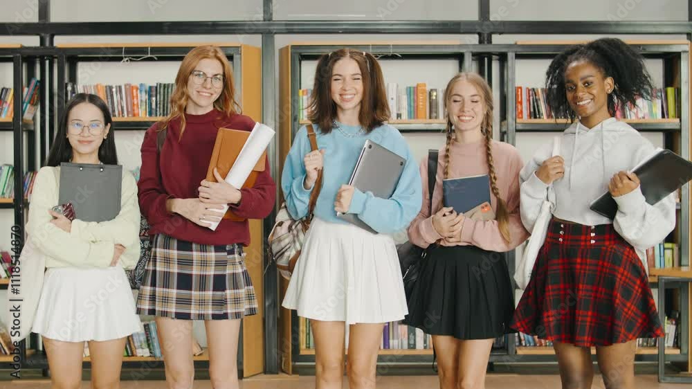 A portrait of five happy multiethnic female students standing in a ...