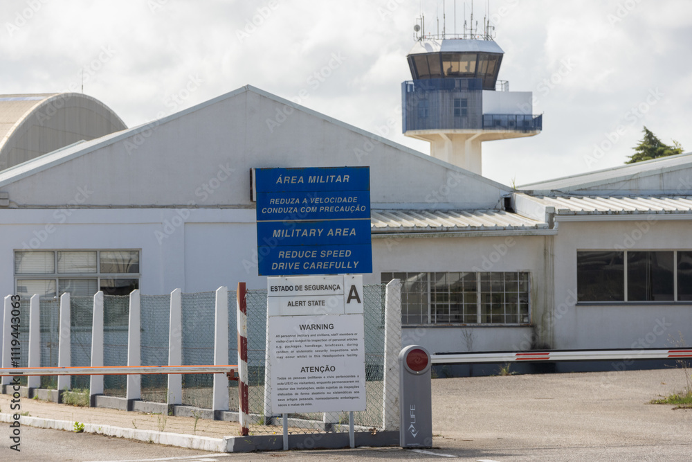 Military area sign at lisbon airport in portugal with control tower ...