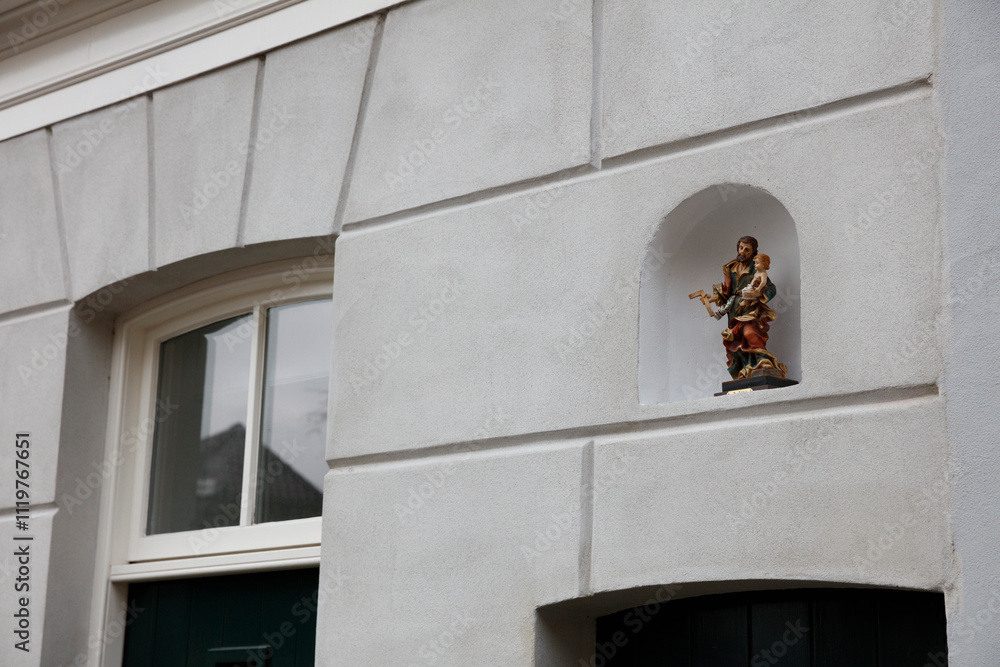 Small religious statue of the Holy Family, nestled in a niche of a ...