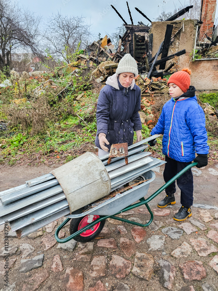 children carry a wheelbarrow with metal, poor children earn money ...