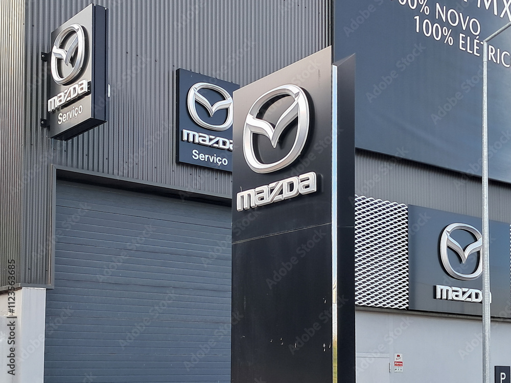 Mazda dealership building showing company logo and service signage ...