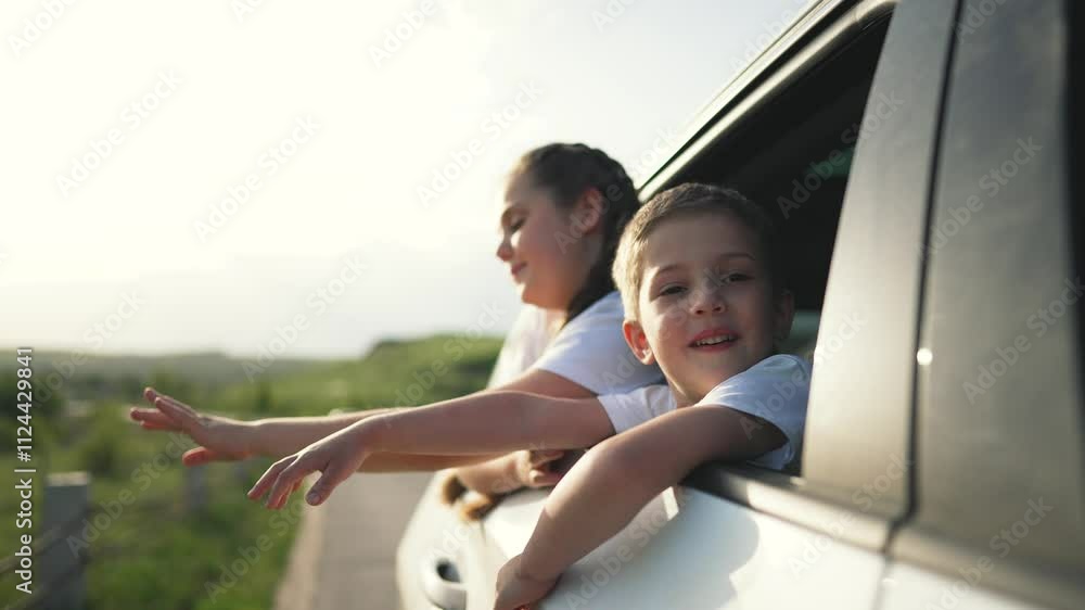 Children on auto trip wave from window. Happy Children stretch hands ...
