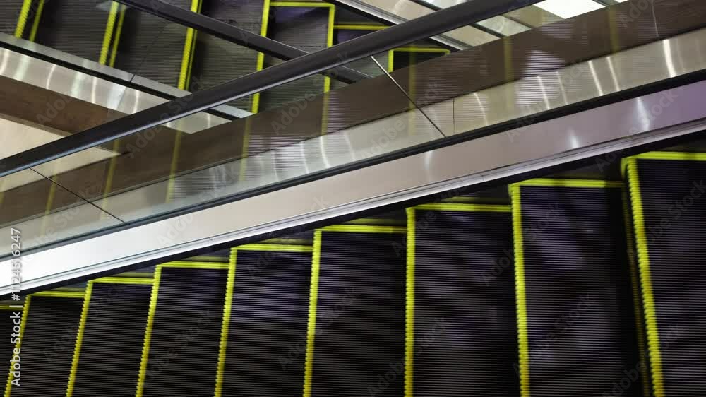 Modern urban indoor escalator leading to a business center or ...