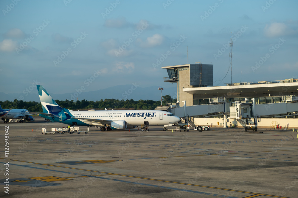 Canadian airliner WestJet plane parked at Licenciado Gustavo Díaz Ordaz International Airport ...