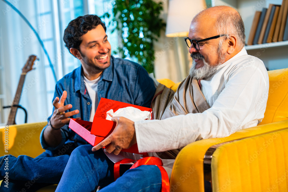Indian Asian Senior father, young son bond over an emotional gift on a ...