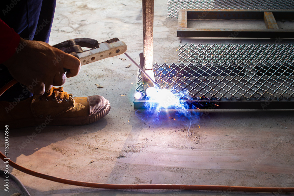 Welder is welding add joint at a construction site weld metal ...