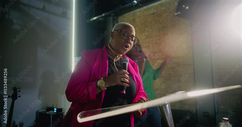 Dynamic pastor delivering a heartfelt message at a podium during a ...