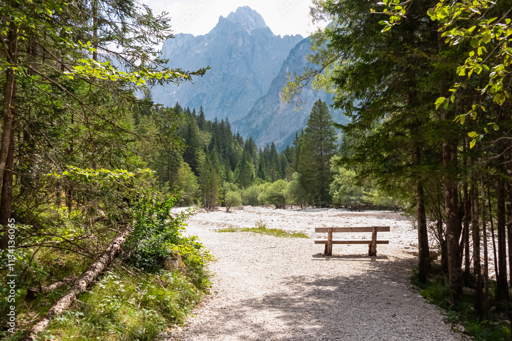 Wooden bench overlooking dried riverbank of Pisnica river winding ...