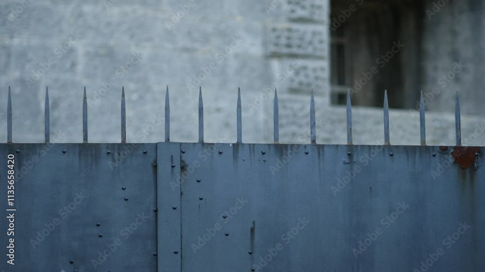 Massive iron gates with sharp spikes on top at an abandoned military ...