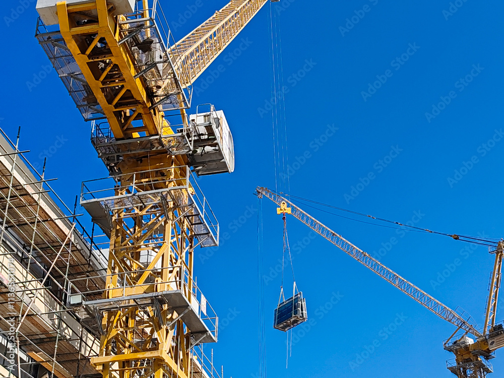 Tower crane or mobile crane erected beside under construction building ...