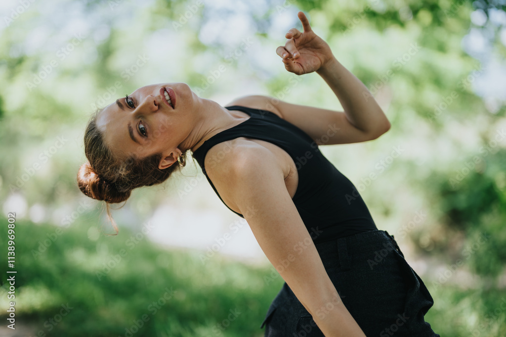 Lovely girl dancing gracefully in nature, showcasing modern dance moves ...