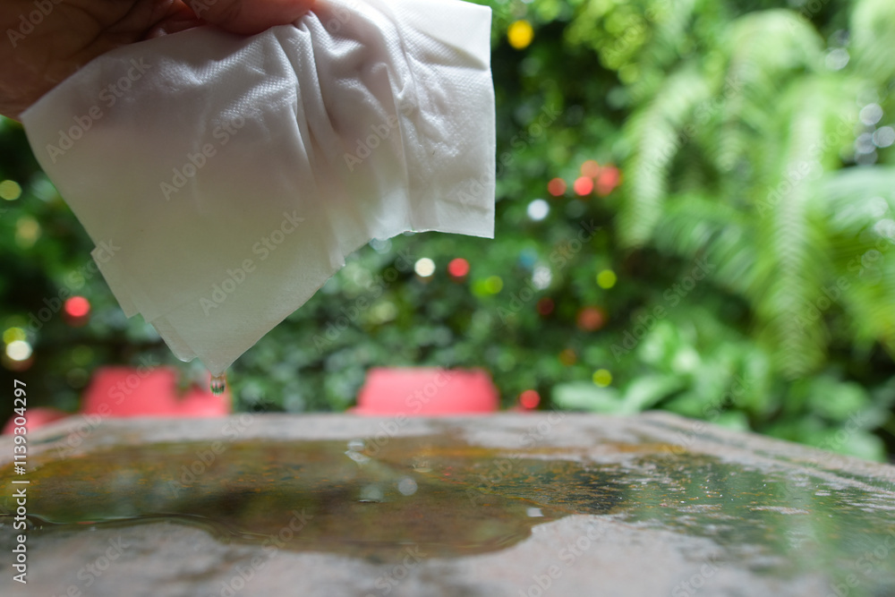 Wipe up the water on the table with paper towels, Water spilled on the ...