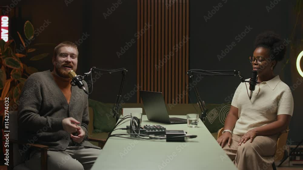 Young friendly Caucasian male radio host starting podcast by greeting ...