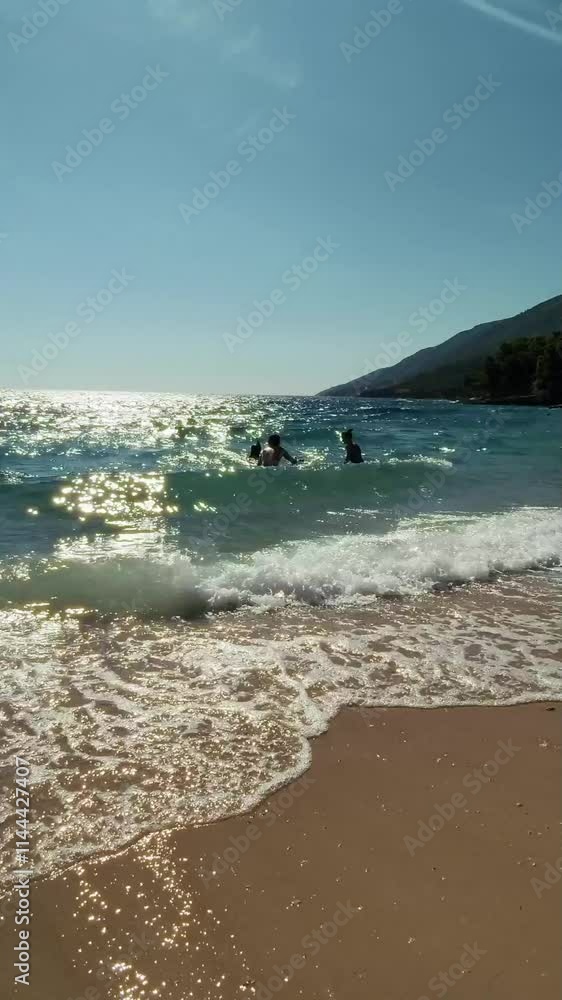 People are swimming in the sea, bouncing and swaying with the waves ...