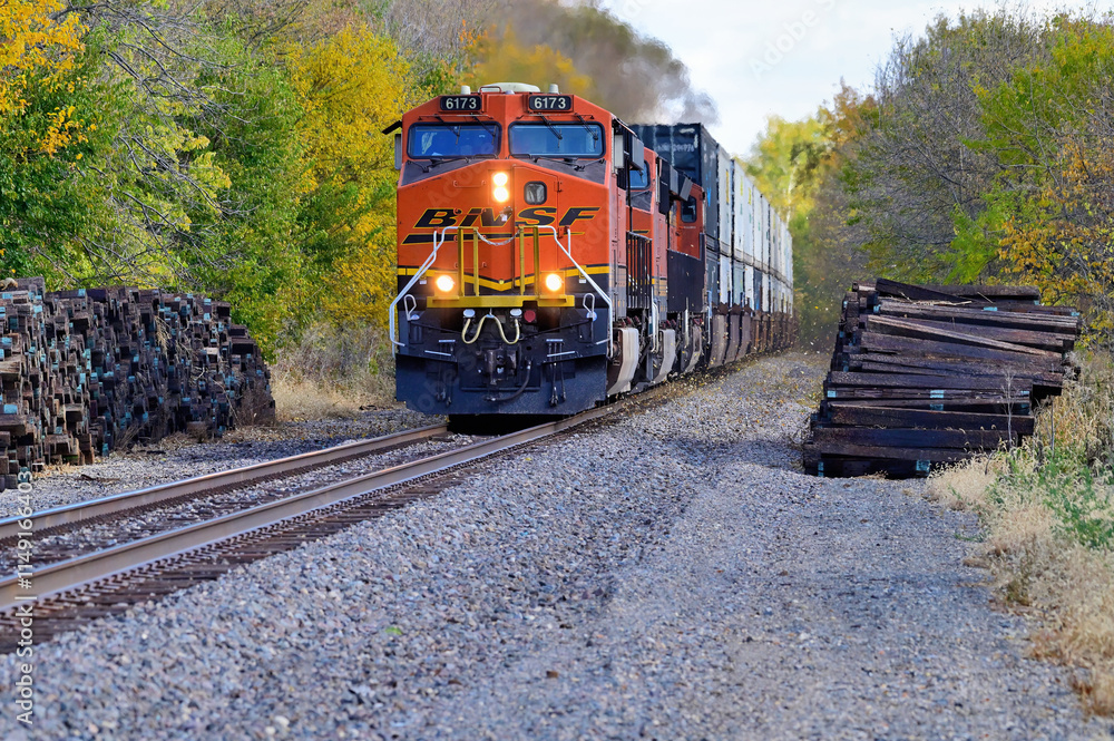 Three locomotives lead a Burlington Northern Santa Fe intermodal freight train as it emerges ...