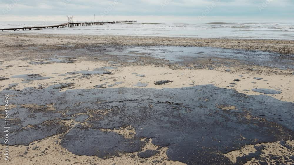 Beach and sea are polluted with oil. Beach oil spill impact, pollution ...
