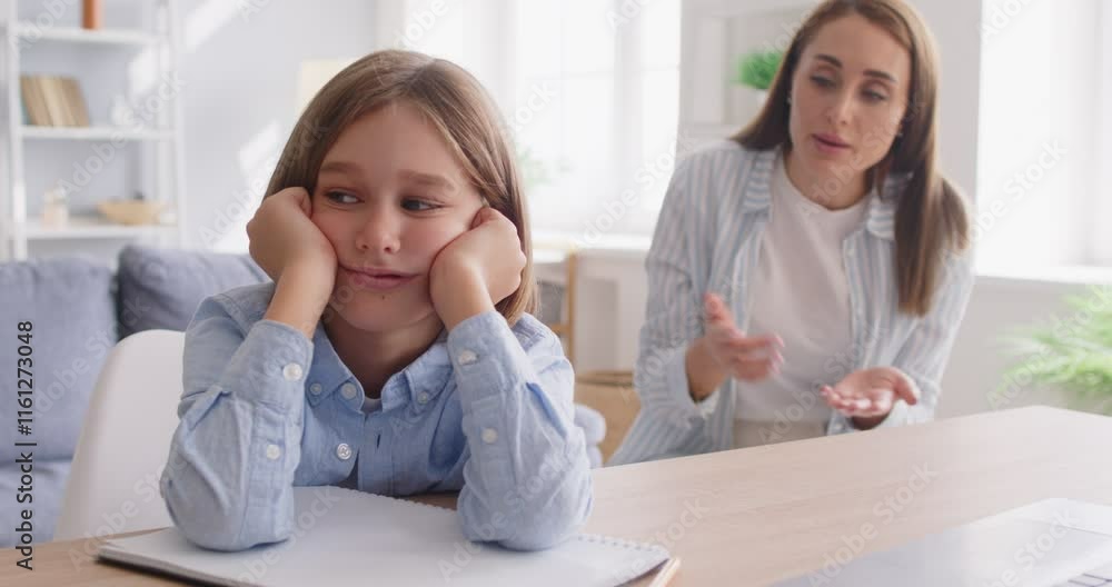 Frustrated mother emotionally scolding her preteen child, expressing ...