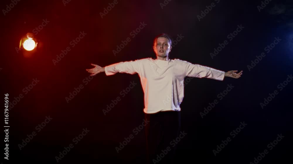 Madness and art, young crazy woman dancing alone in studio, looking at ...