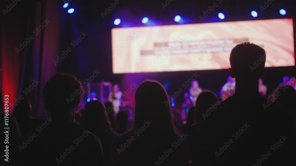 Young girl lifting hand up during christian worship night performing ...