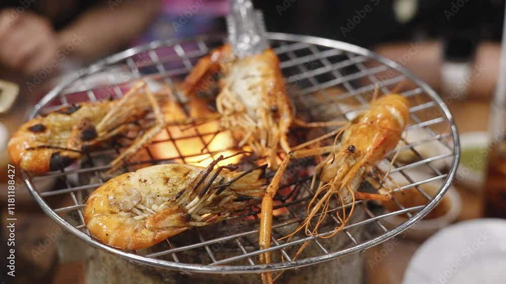 Stockvideon A plate of grilled shrimp and other seafood is being cooked ...