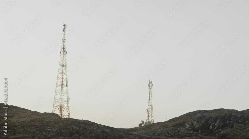 Two tall telecommunication towers are located on an elevated area of ...