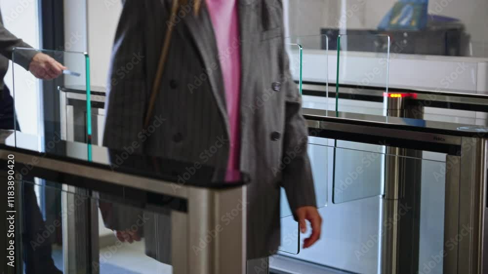 Passing through a turnstile into an office building. Office workers ...