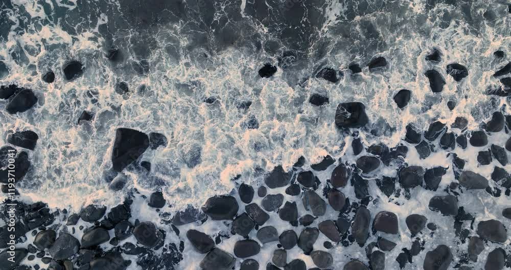 Water Background Surface of frosty stones and rocks and sea waves on ...