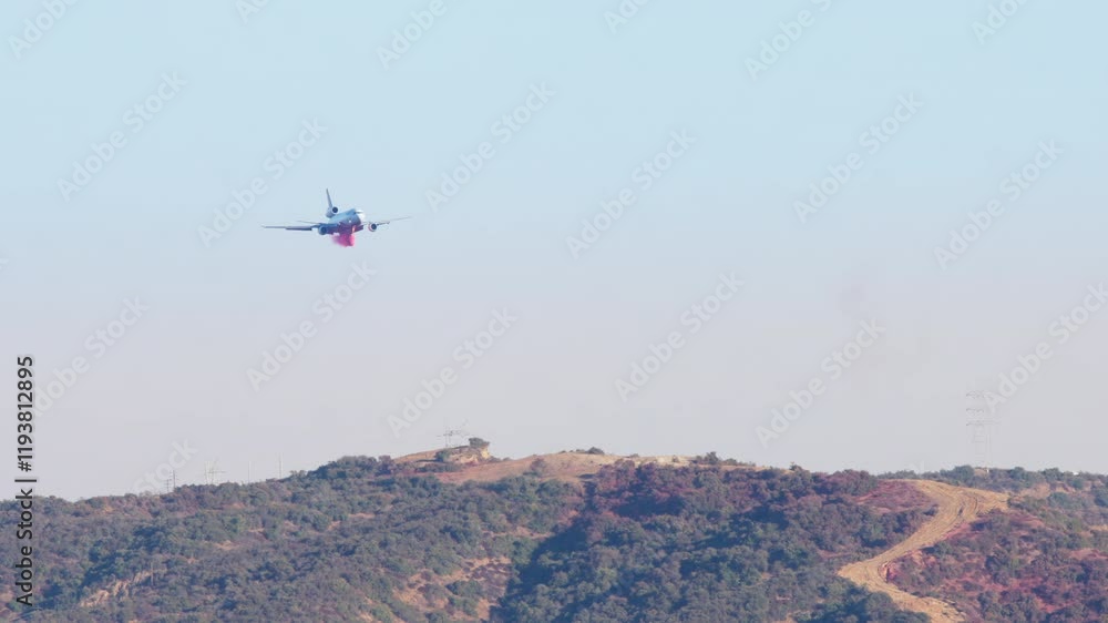 In January 2025, a specialized aircraft drops pink water on wildfires ...