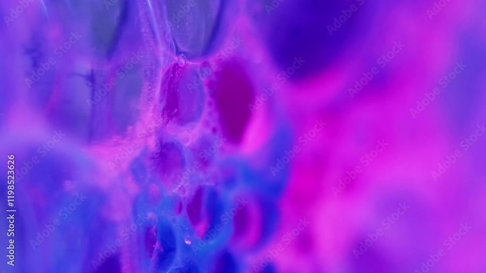 Vertical video. Bubble fluid. Wet foam. Defocused neon pink purple blue ...