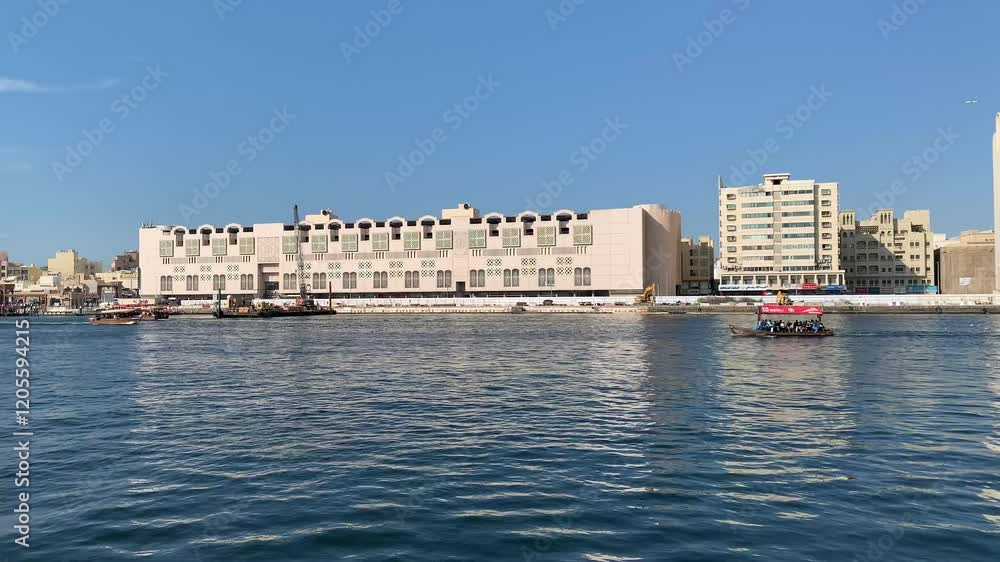 Traditional Emirati Abra boat sails through Dubai creek. Flag of the ...