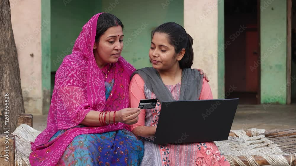Rural indain mother and daughter using laptop and debit credit card for ...
