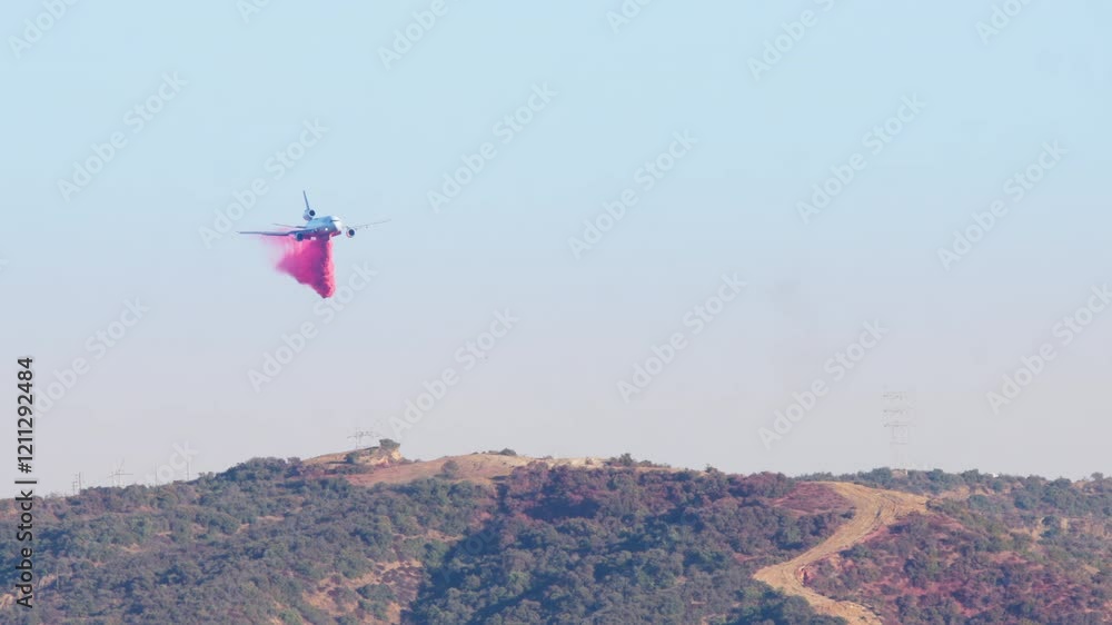 In January 2025, a specialized aircraft drops pink water on wildfires ...
