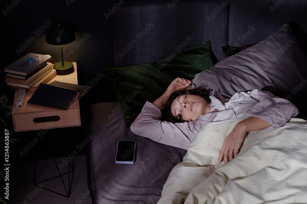 Poster High angle shot of tired woman immersed into deep sleep on ...