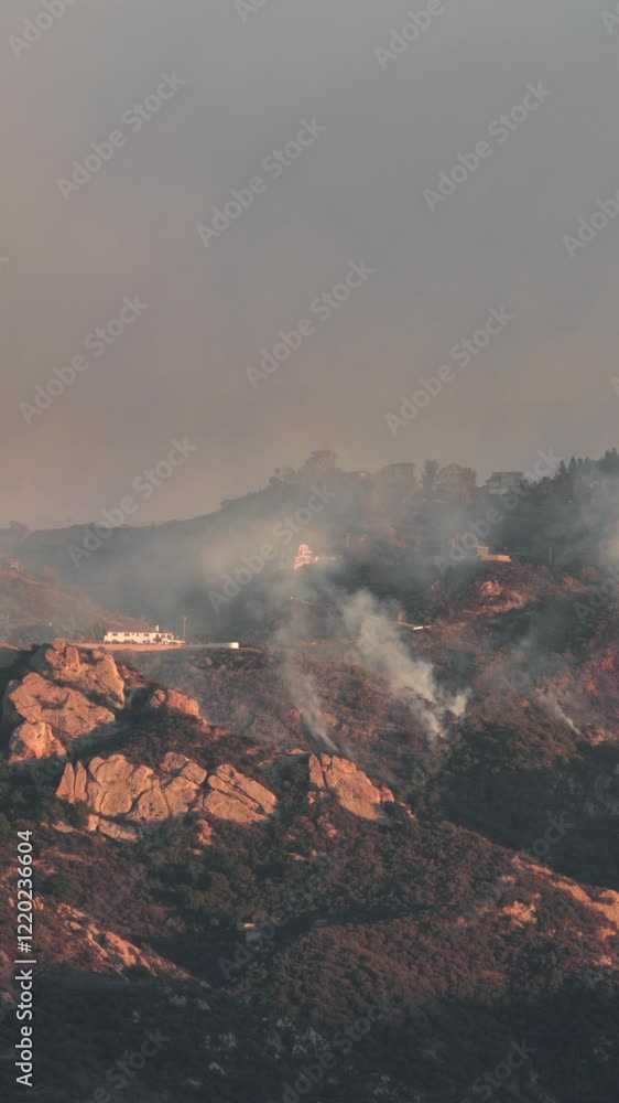 Thick, dark smoke rises from a fierce, uncontrollable fire in the ...
