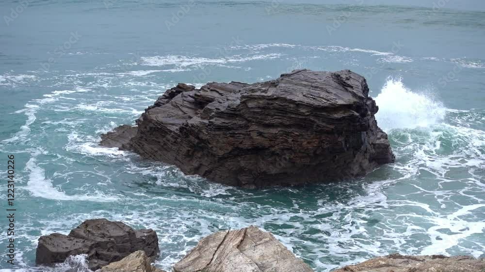 Majestic Rock Amidst Ocean Waves in Galicia - Static view of a massive ...