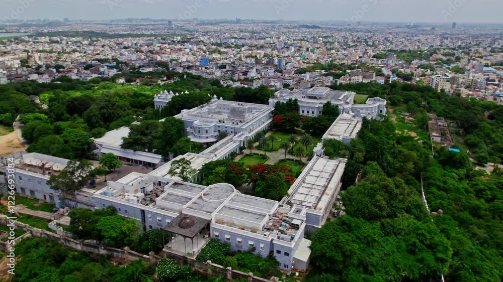 top down drone view of falaknuma palace with trees and crowded ...