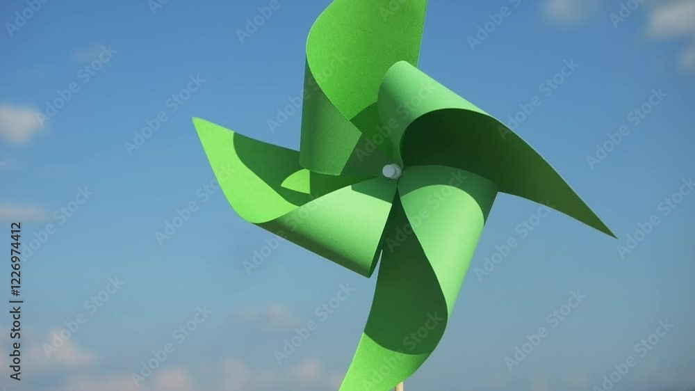renewable energy concept vertical video. green paper pinwheel in hands ...