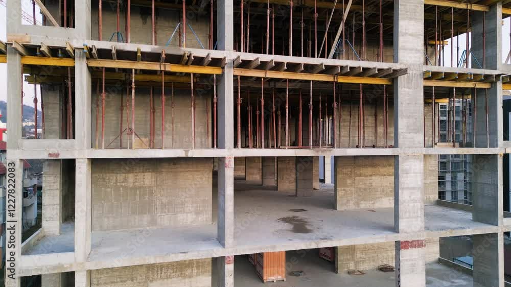 Close-up aerial view of an unfinished high-rise building under ...
