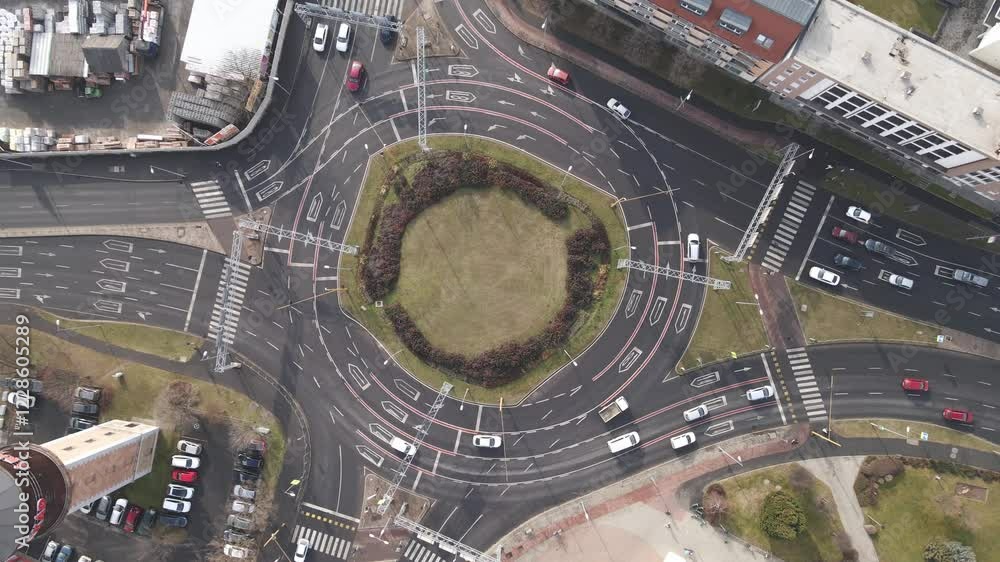 An aerial video of a busy multi-lane roundabout with clearly marked ...