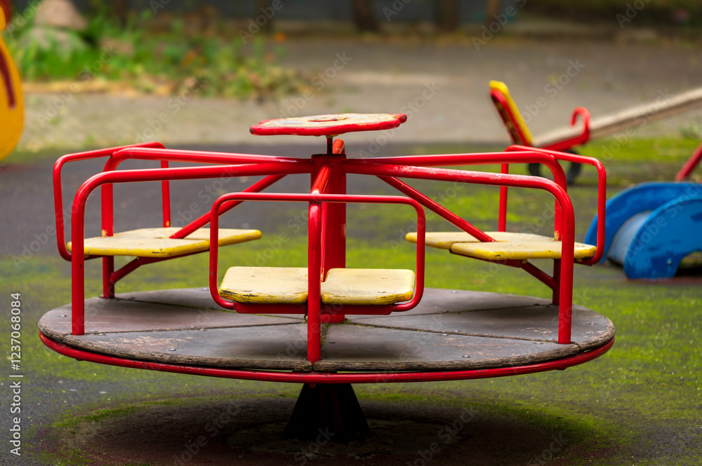 Poster A weathered red merry-go-round sits alone in a deserted ...