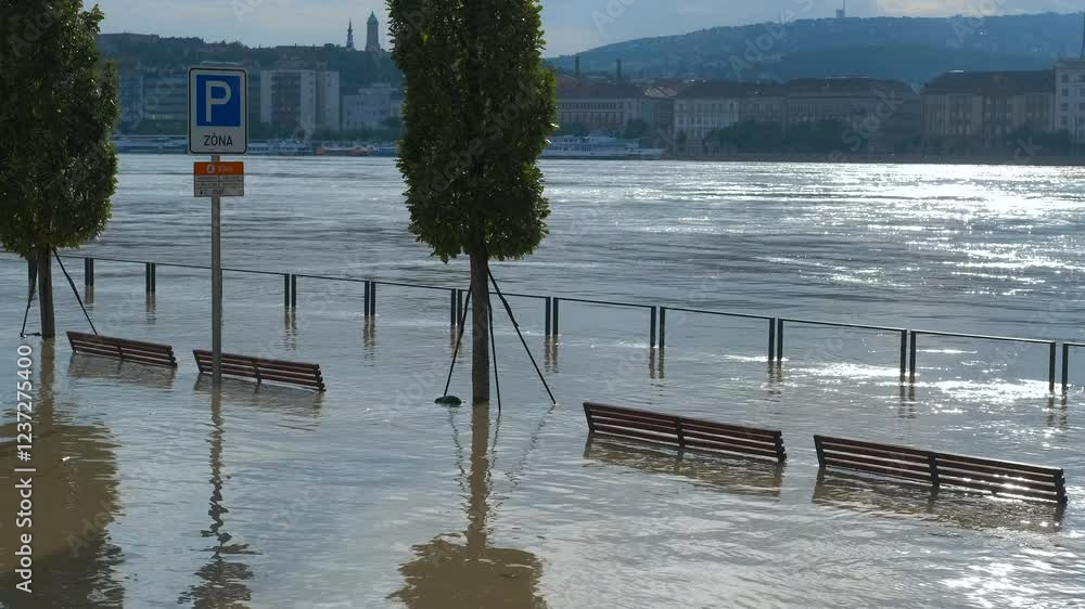 Catastrophic flooding. Parking lot submerged under rising river water ...