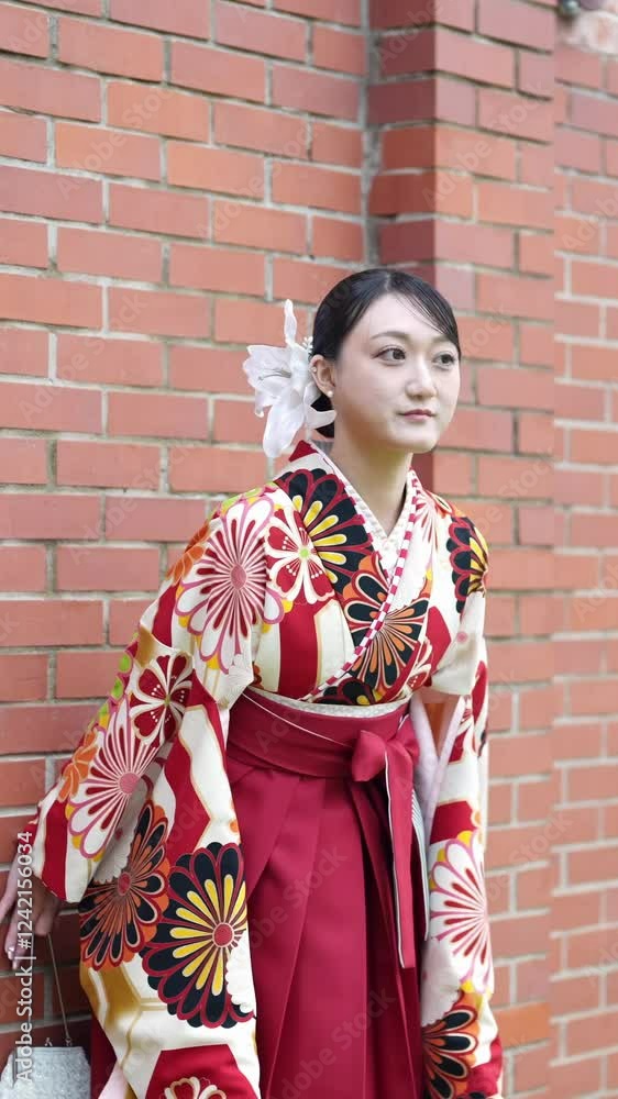 A young woman in her 20s wears a traditional graduation ceremony Hakama ...