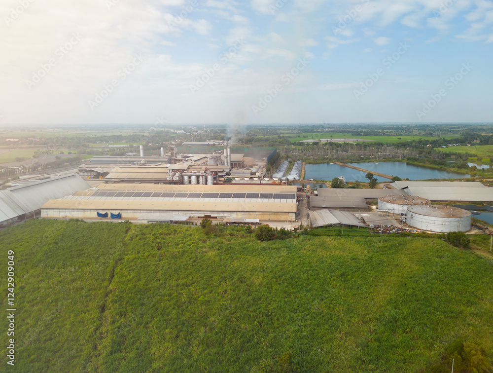 Aerial view of sugar cane plantation with sugar factory industry line ...