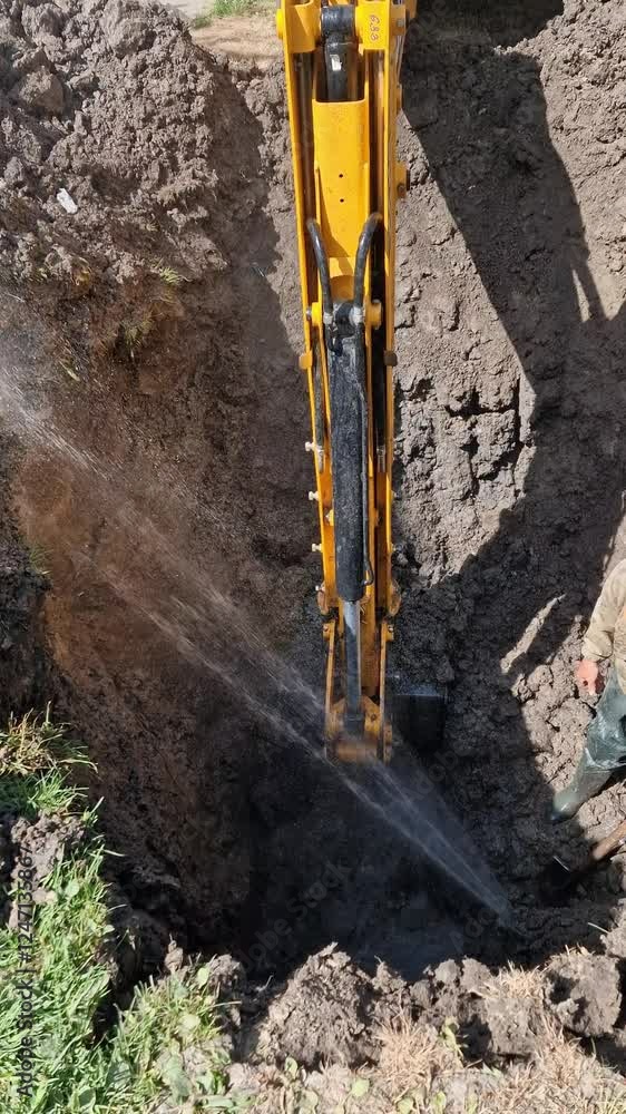 Vertical video. A stream of water flows from the hole where the water ...