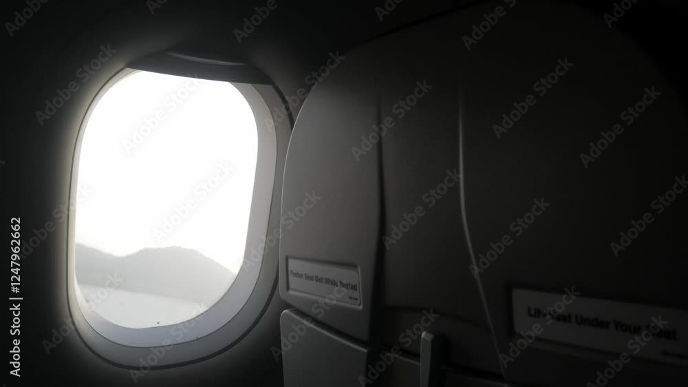 selective focusing view to plane window of airplane while take off from ...