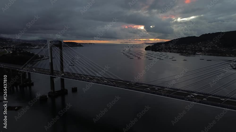 Camera glides over iconic Rande Bridge at sunset, revealing the calm ...